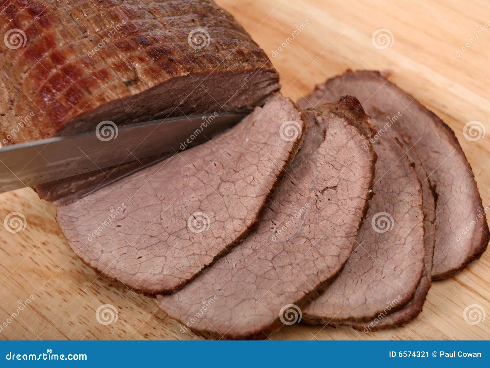Slicing a round beef joint stock image. Image of sliced - 6574321