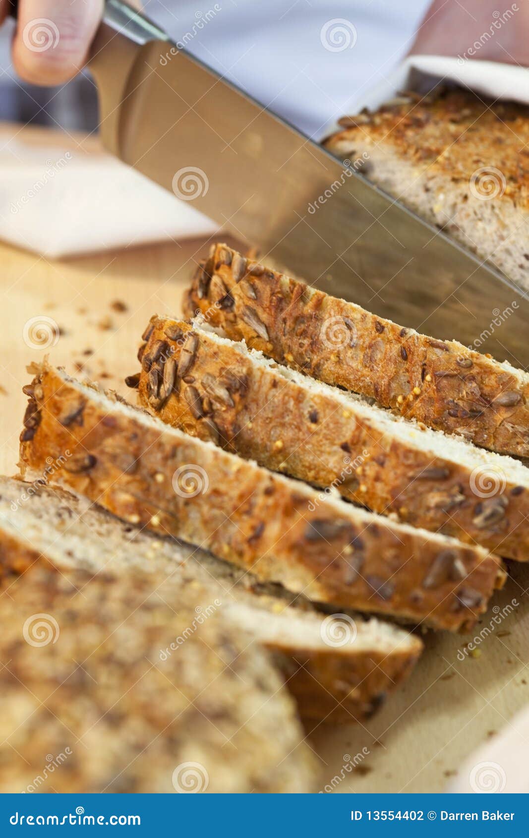 Slicing Rustic Wholemeal Seeded Loaf of Bread Stock Photo - Image of ...
