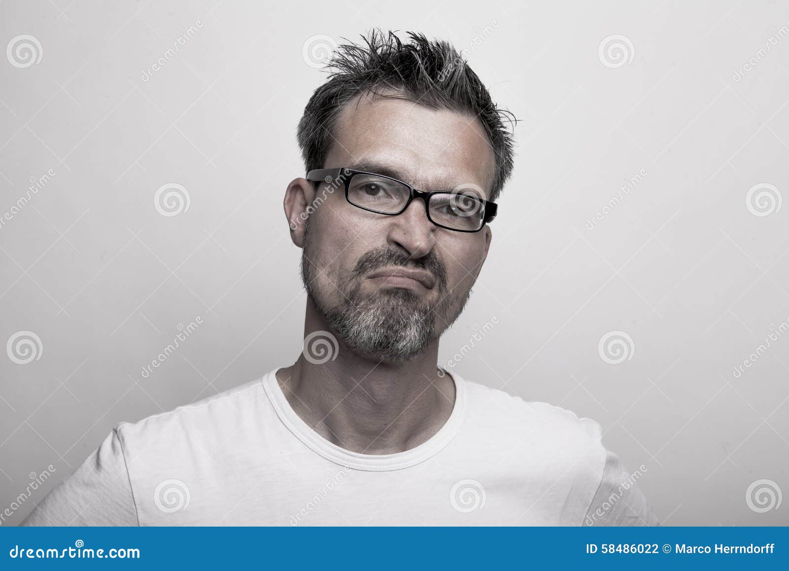 Slightly annoyed man stock photo. Image of stubbly, haircut - 58486022