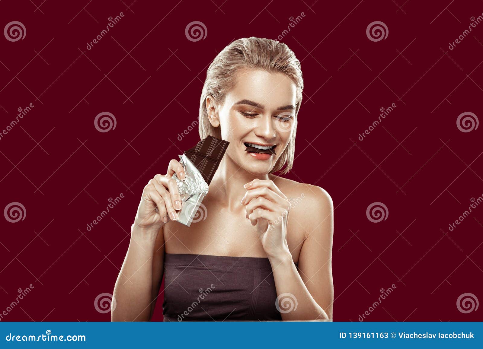 Slim Appealing Model Feeling Cheerful while Eating Chocolate Stock ...