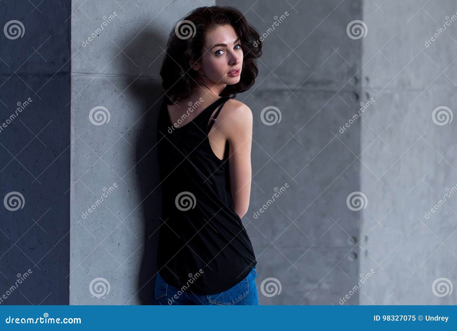 Slim Young Brunette Turning Head Looking Back Standing at Wall Stock ...