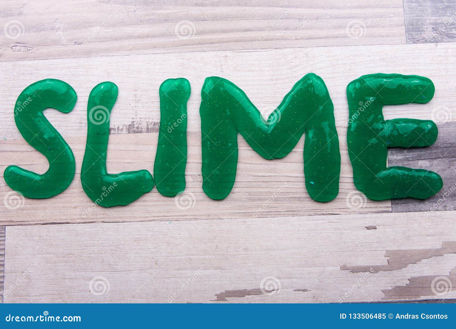 Slime Text Made from Green Slime on a Wooden Surface Stock Image ...