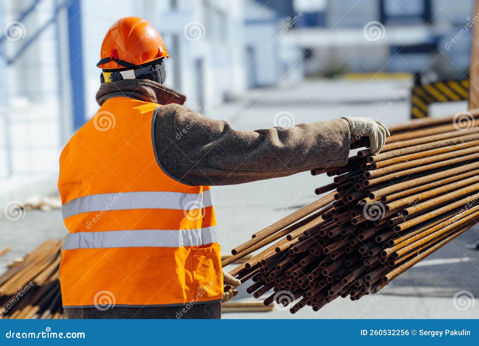 Slinger in Construction Helmet and Orange Vest Unloads Cargo on ...