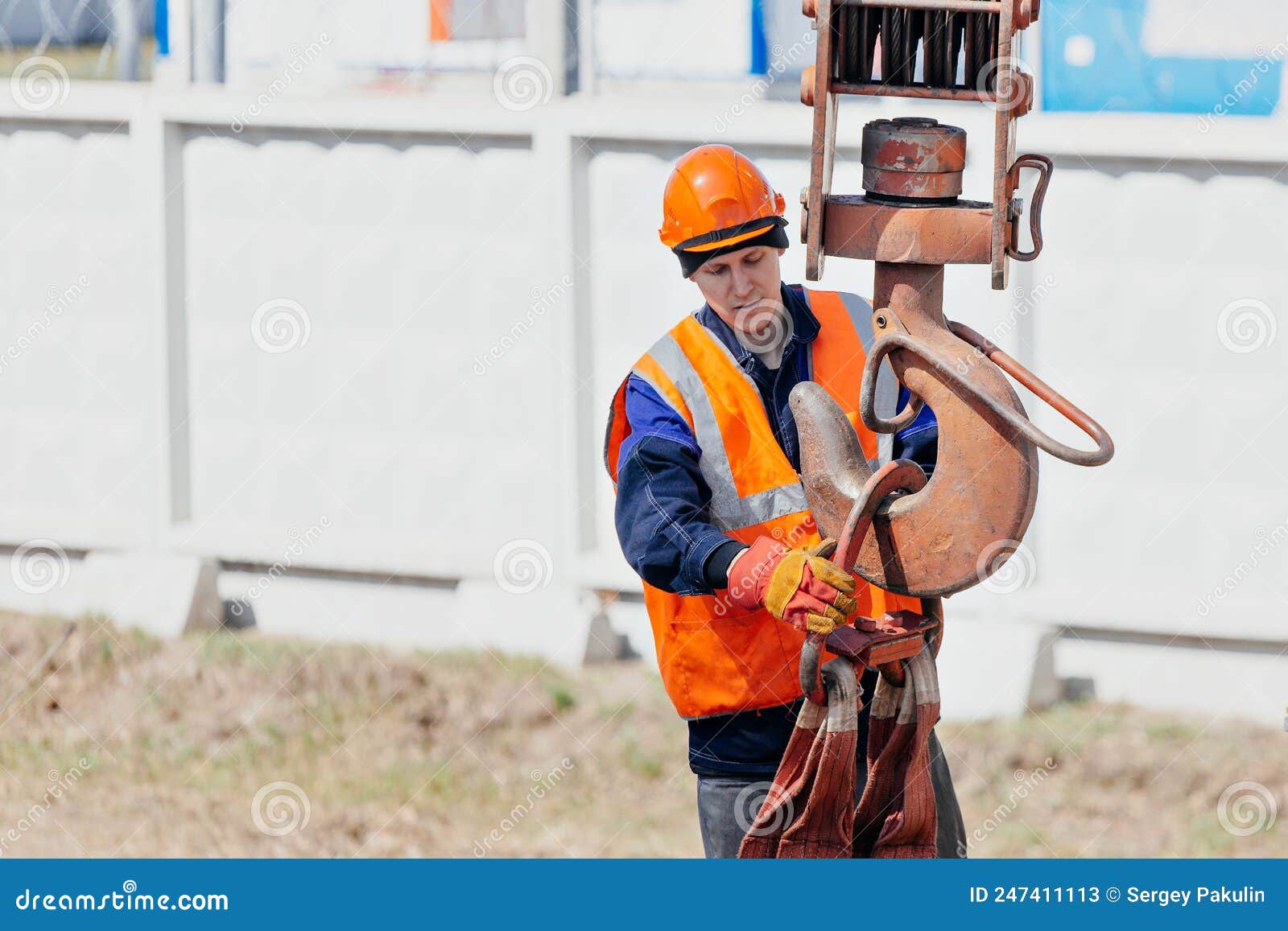 Slinger In Helmet And Vest Unloads Metal Pipes And Fittings From Truck ...