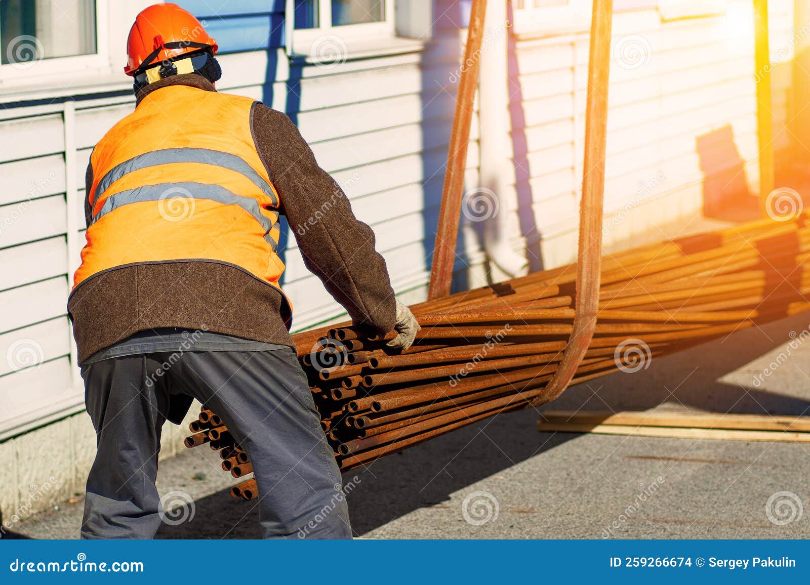 Slinger Stacks Thin Metal Pipes in Stack on Construction Site. Close-up ...