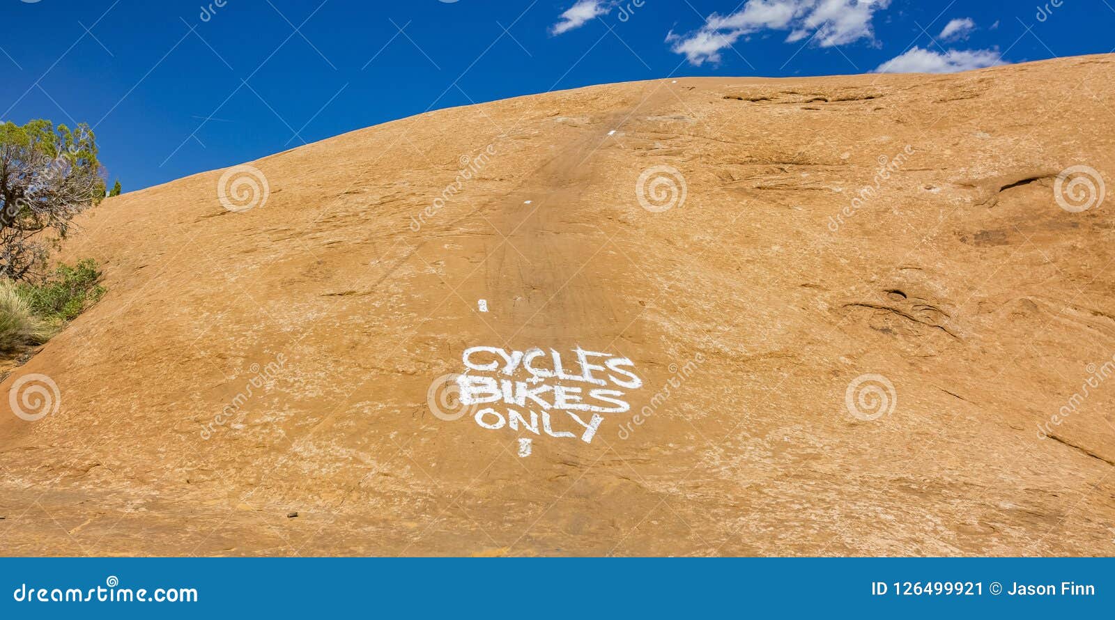 Sloping Path for Bikers Beneath a Bright Blue Sky Stock Image - Image ...