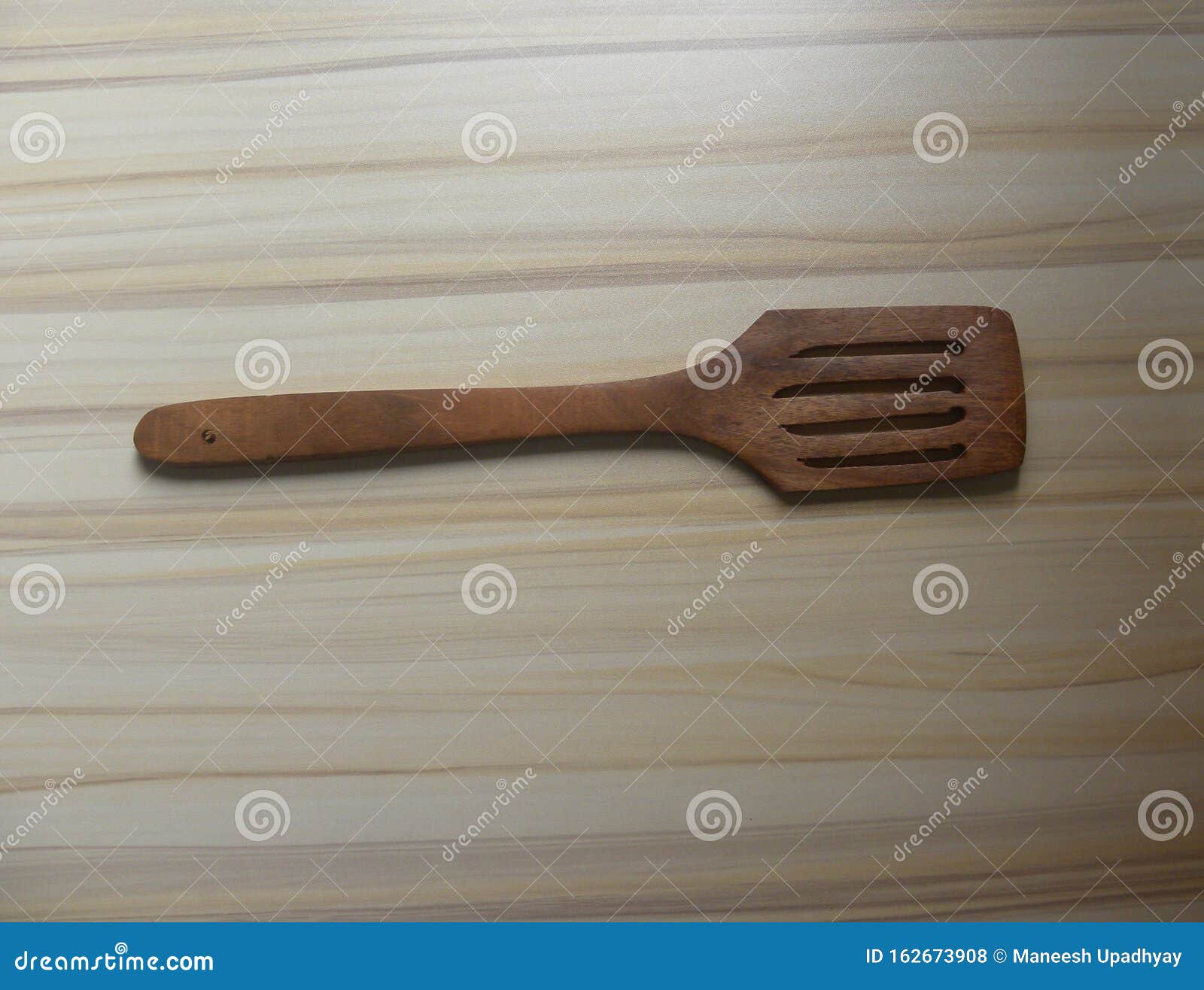 Slotted wooden spatula stock photo. Image of design - 162673908
