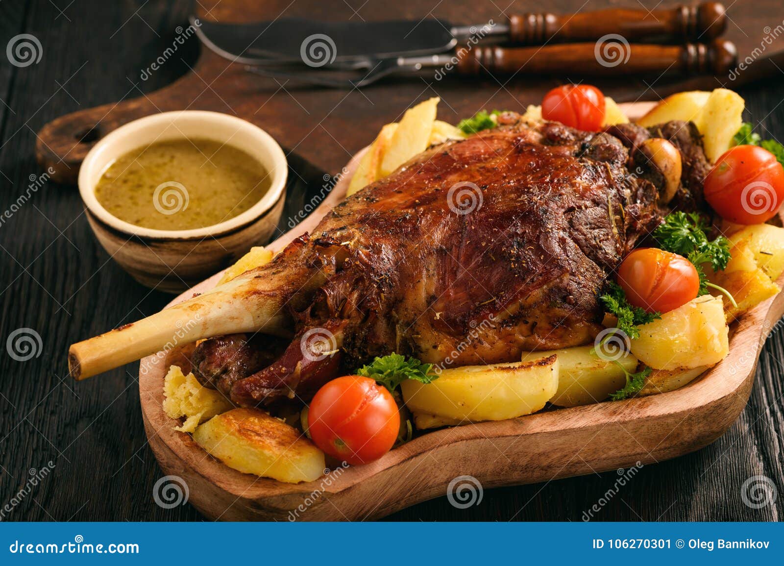 Slow Baked Lamb Leg With Potatoes And Sauce. Royalty-Free Stock ...