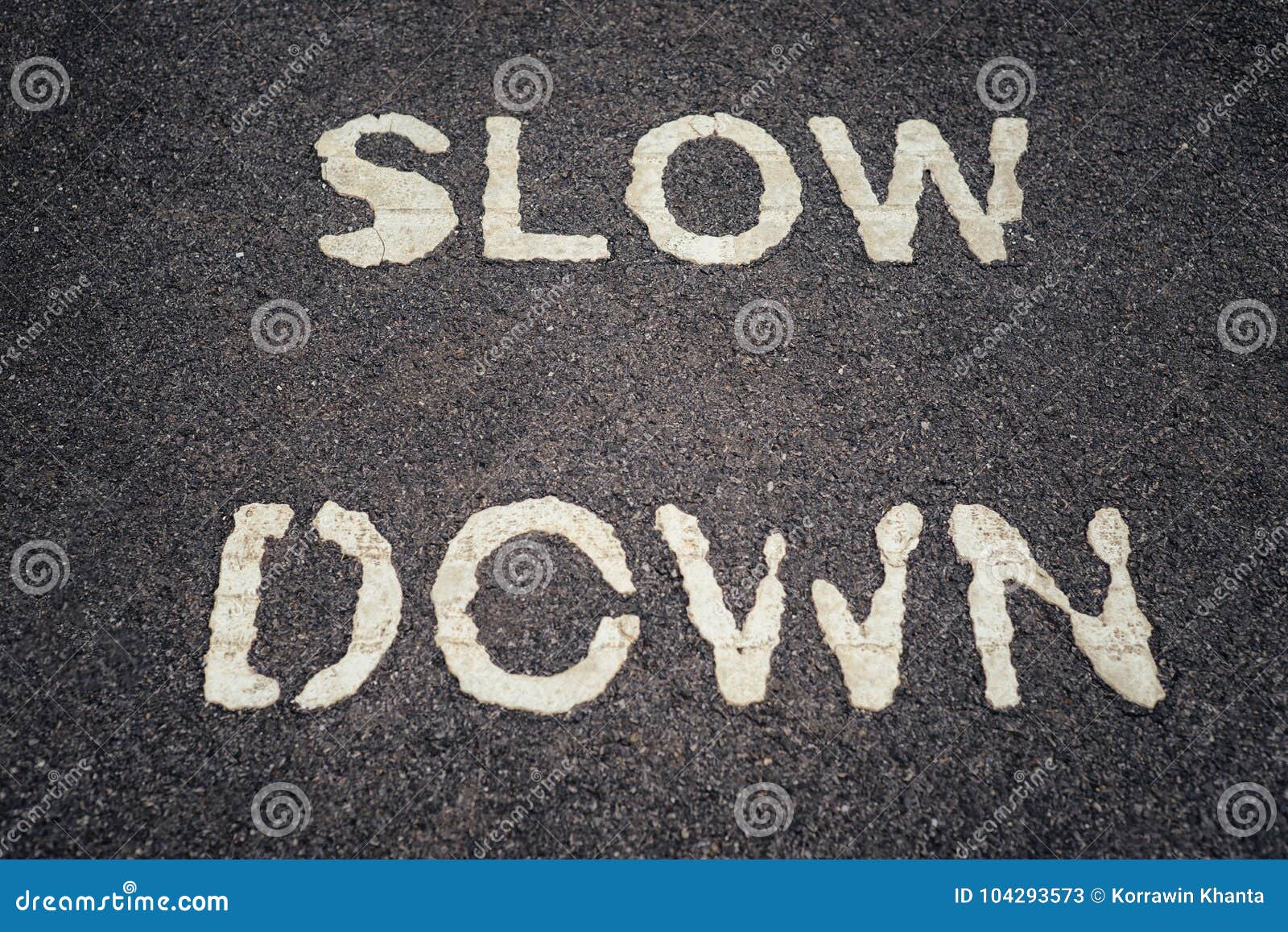 SLOW DOWN print on asphalt stock image. Image of limit - 104293573