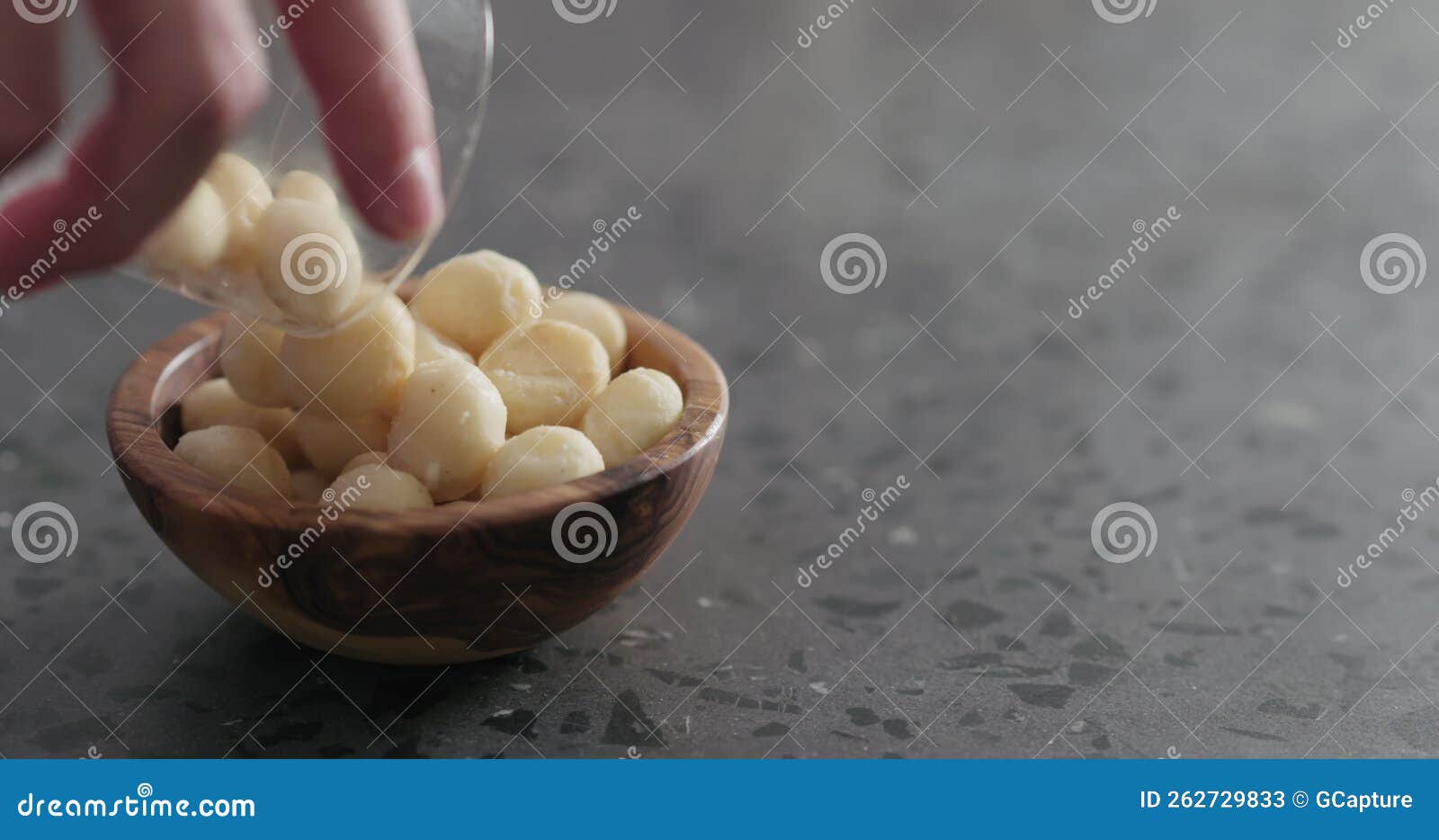 Slow Motion Peeled Macadamia Nuts Fall into Olive Wood Bowl Stock Video ...