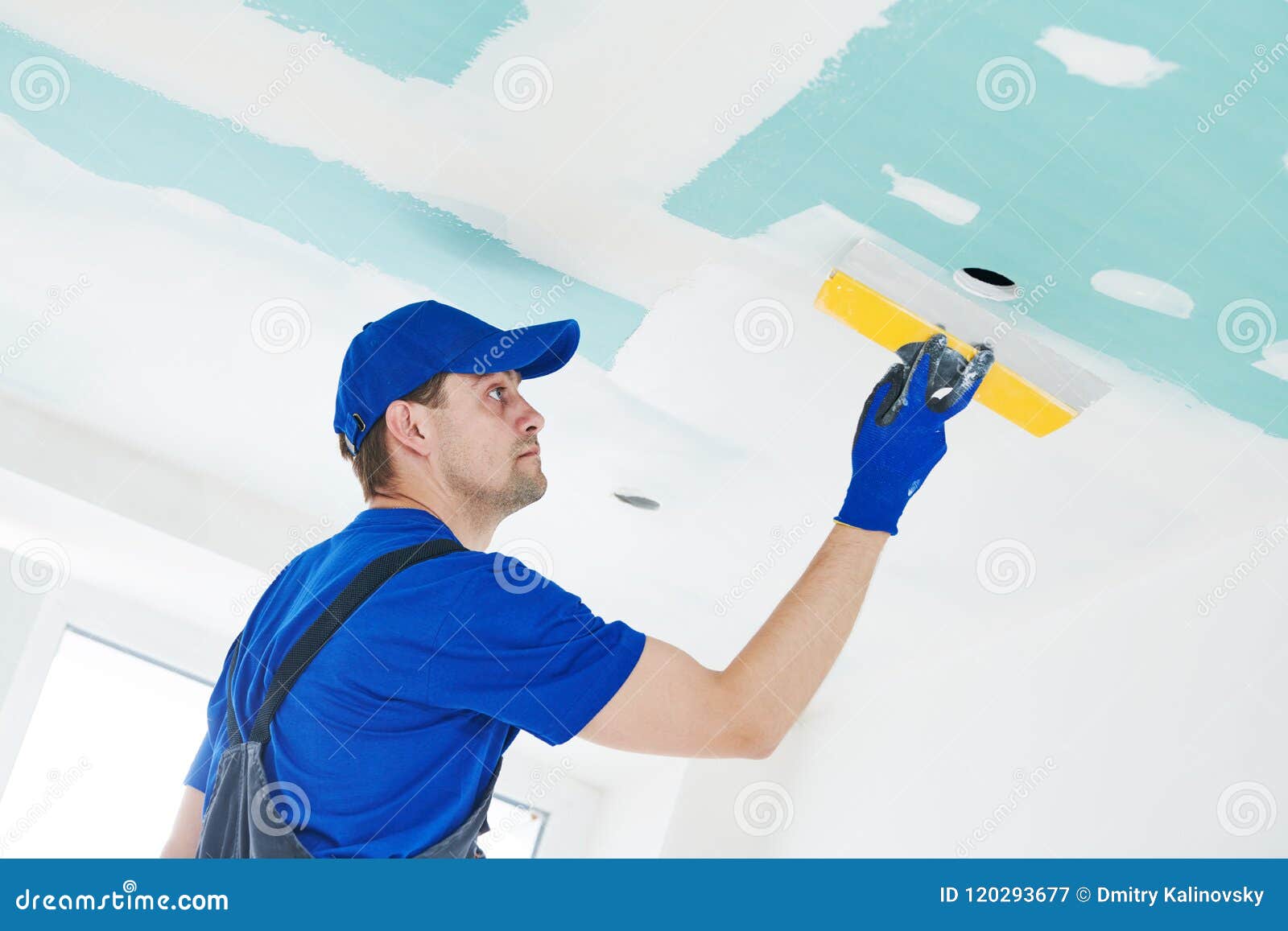 Refurbishment. Plasterer Spackling a Gypsum Plasterboard Ceiling with ...