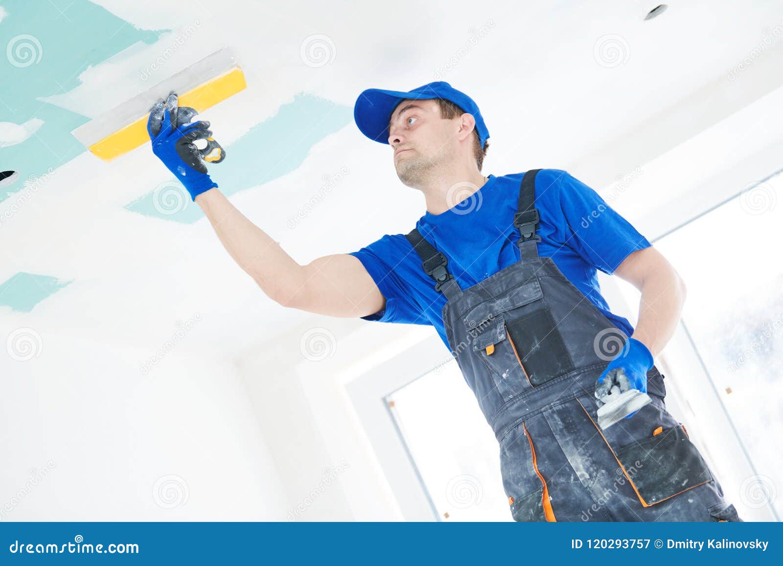 Refurbishment. Plasterer Spackling a Gypsum Plasterboard Ceiling with ...