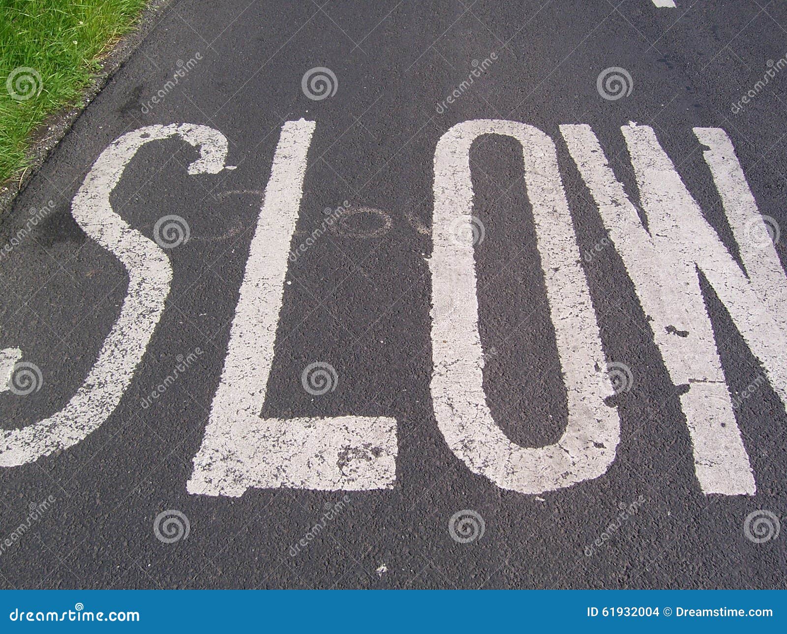 Slow Sign painted on road stock photo. Image of white - 61932004