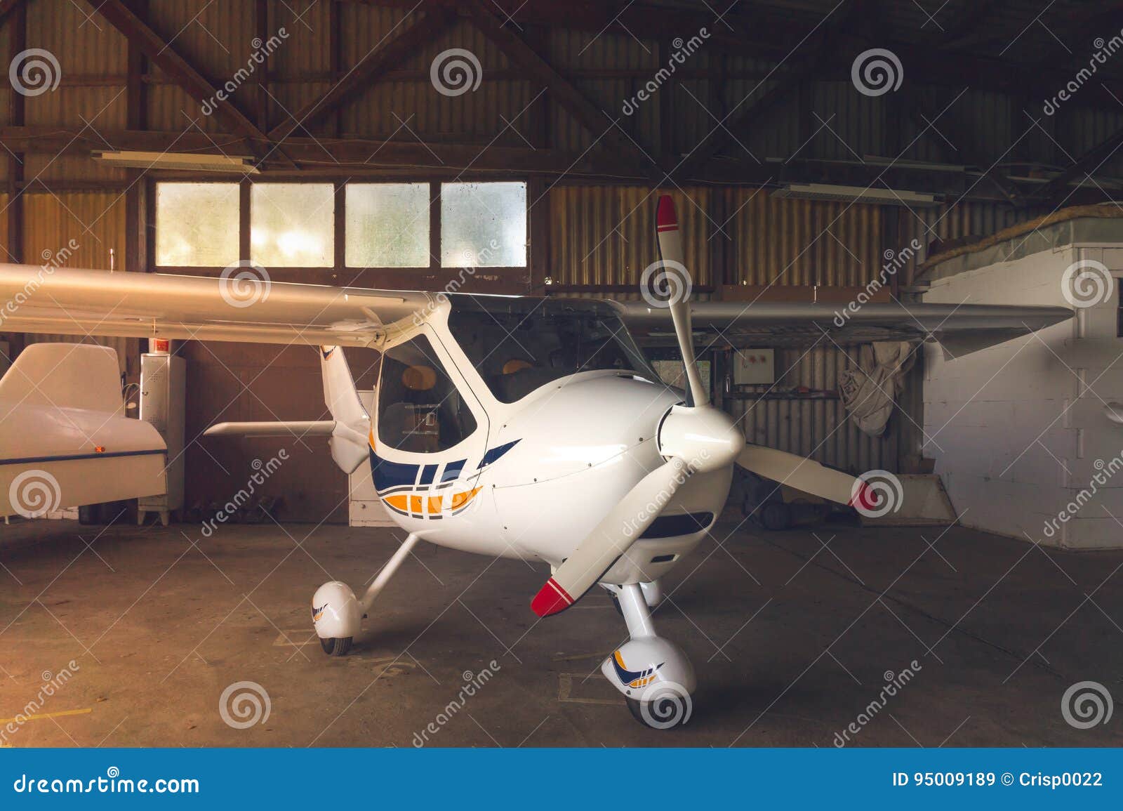 Small aircraft in a hangar stock image. Image of aeroplane - 95009189