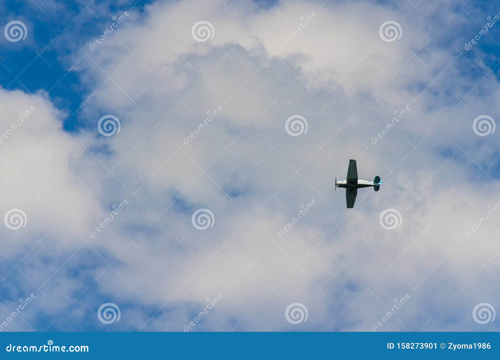 Small Airplane Flying in the Sky with Clouds in the Summer Season Stock ...
