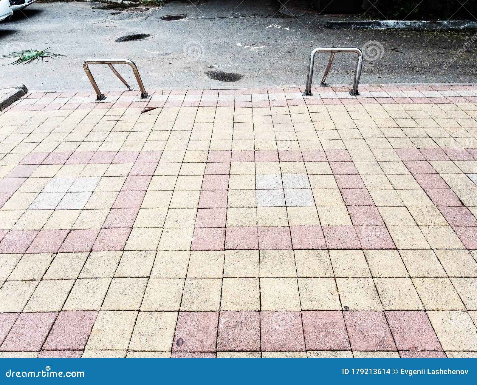A Small Area with Paving Tiles and Two Barriers Stock Photo - Image of ...