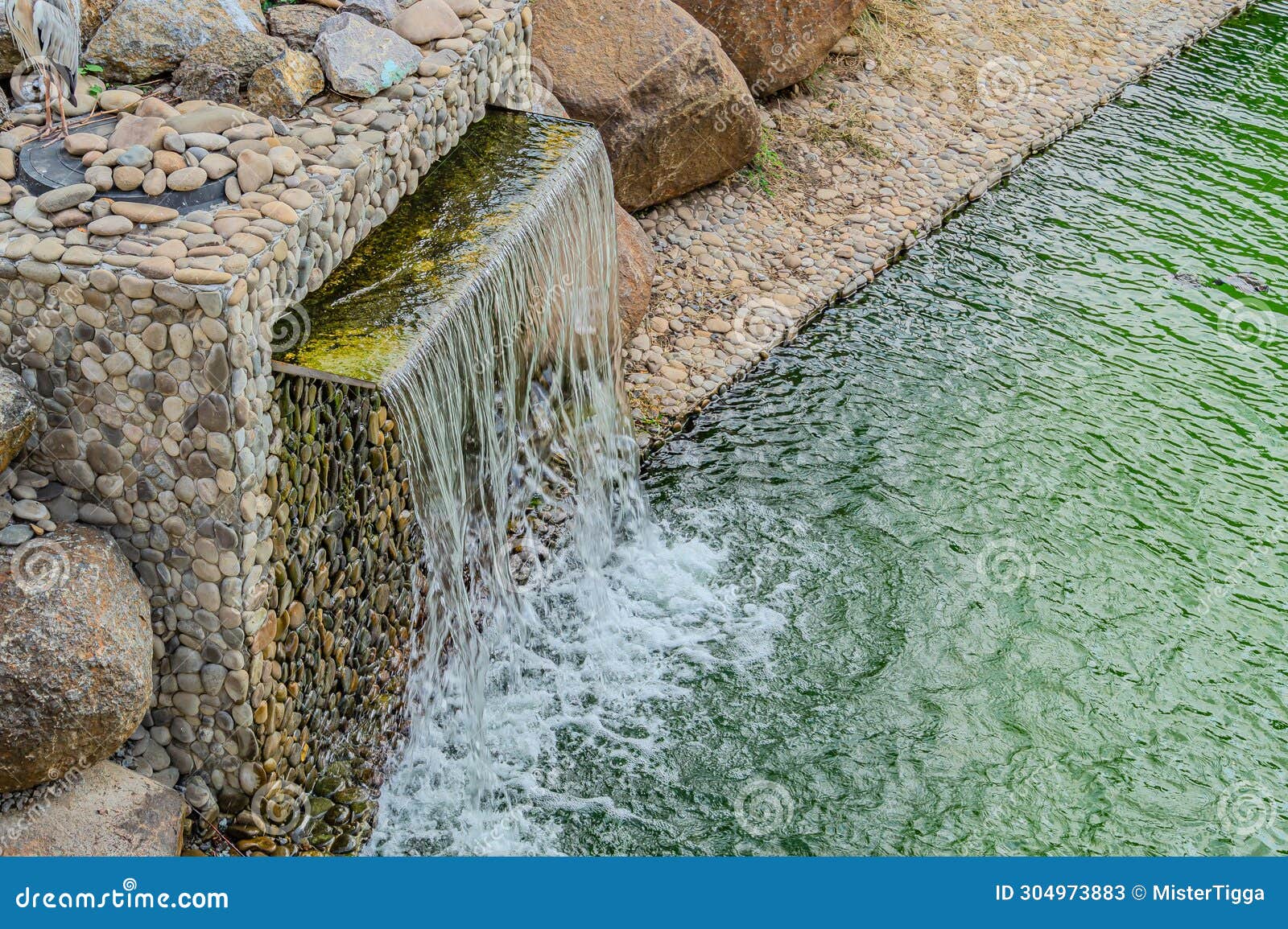 Small Artificial Waterfall in Man Made Tropical Garden. a Small ...