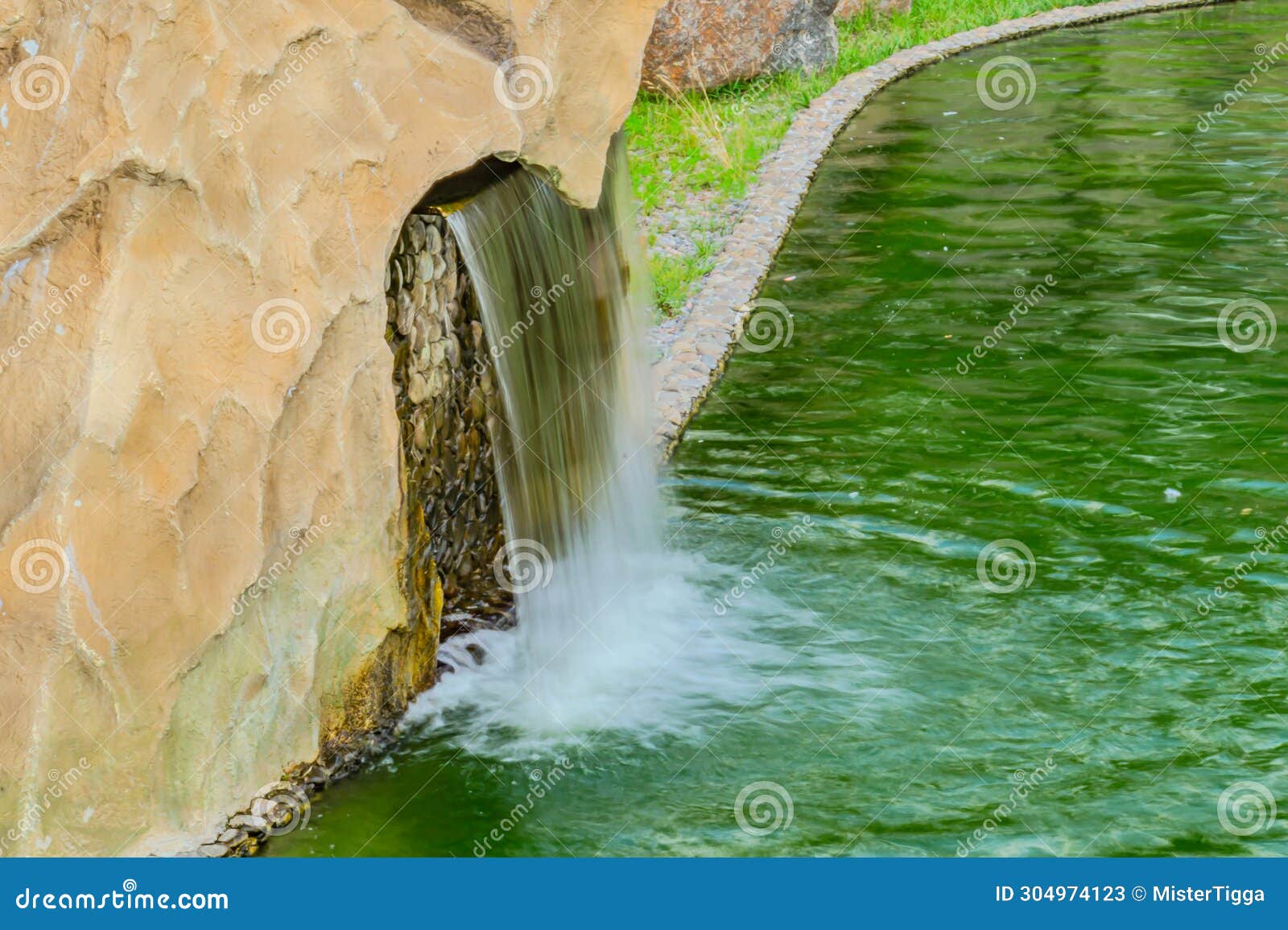 Small Artificial Waterfall in Man Made Tropical Garden. a Small ...