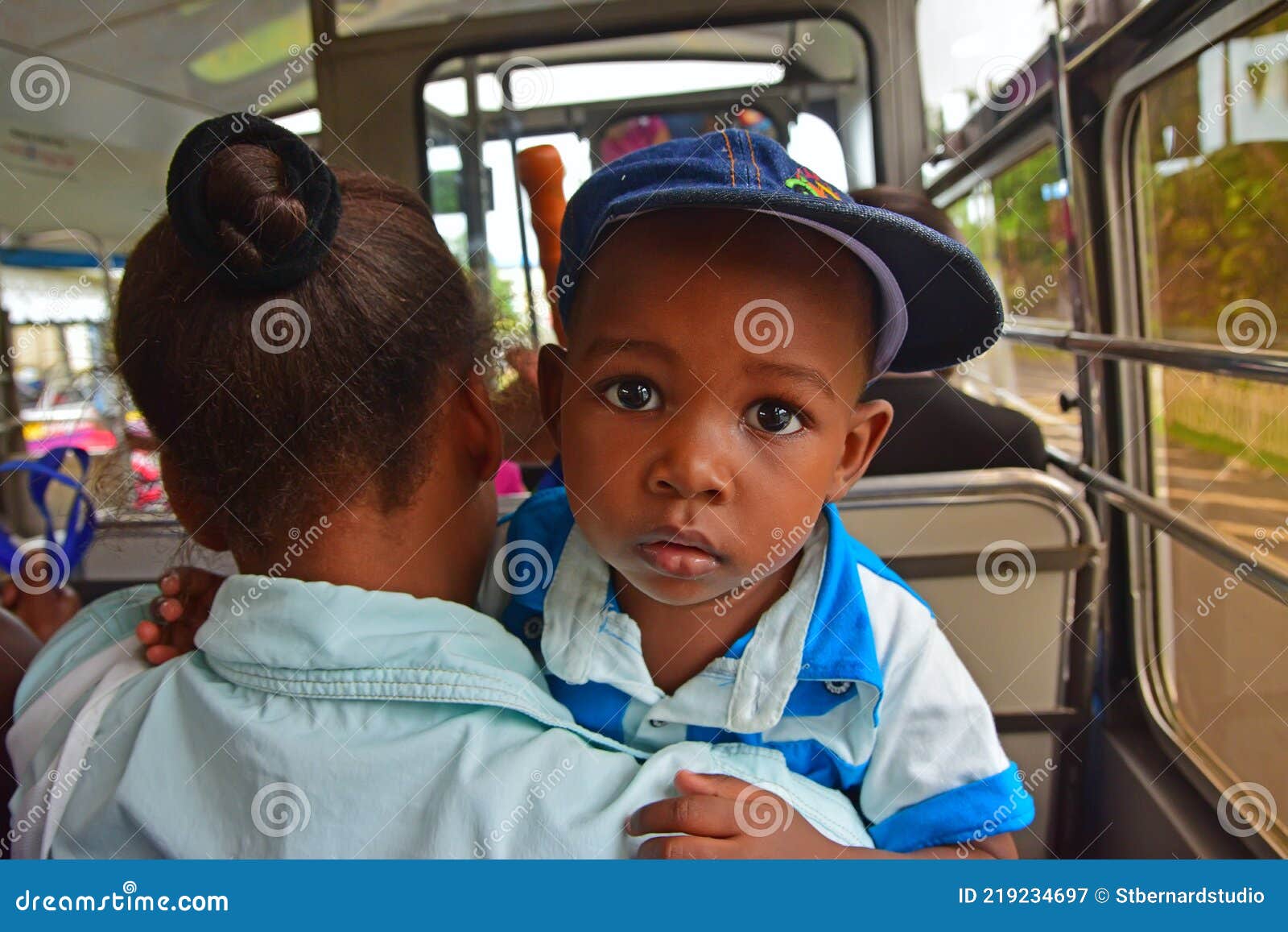A Cute yet Curious Little Rodriguan Baby Being Carried by His Mother in ...