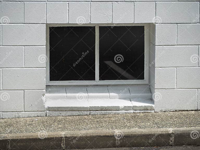 Small Basement Window with Security Mesh on White Brick Wall Stock ...