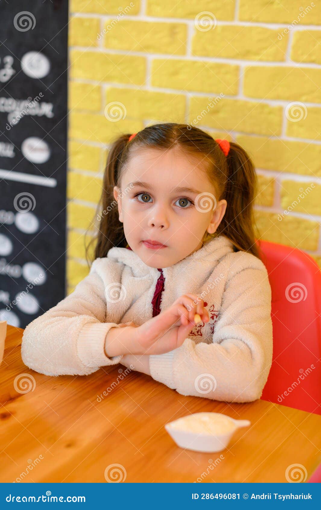 A Small And Beautiful Girl Is Eating French Fries In A Cafe Stock Image Image Of Meat