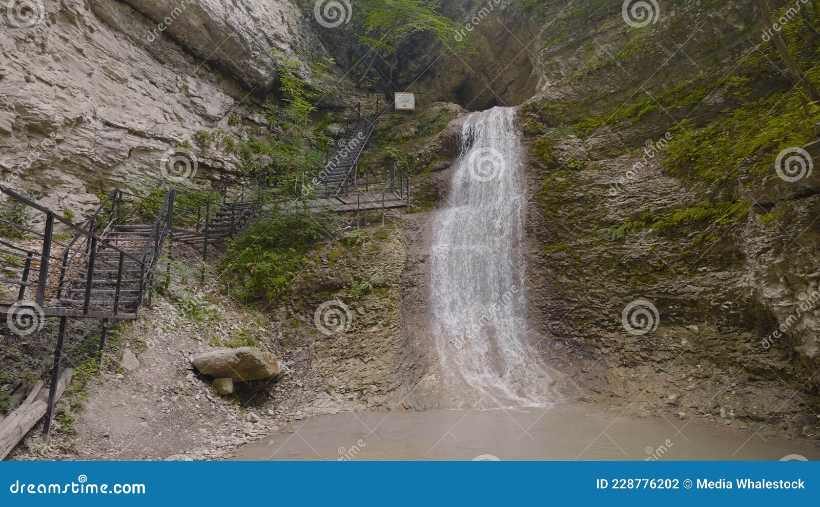 A Gentle Flowing Cascade Waterfall Surrounded By Lush Greenery Royalty ...