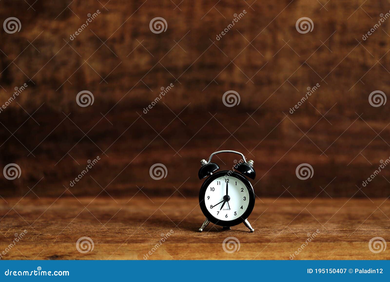 Small Black Clock on Rustic Brown Wooden Table Stock Image - Image of ...
