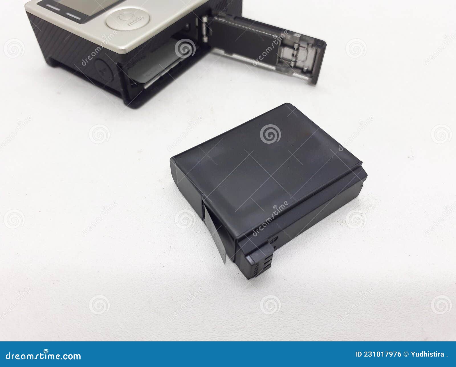 A Small Black and Grey Action Camera with Its Accessories on White ...