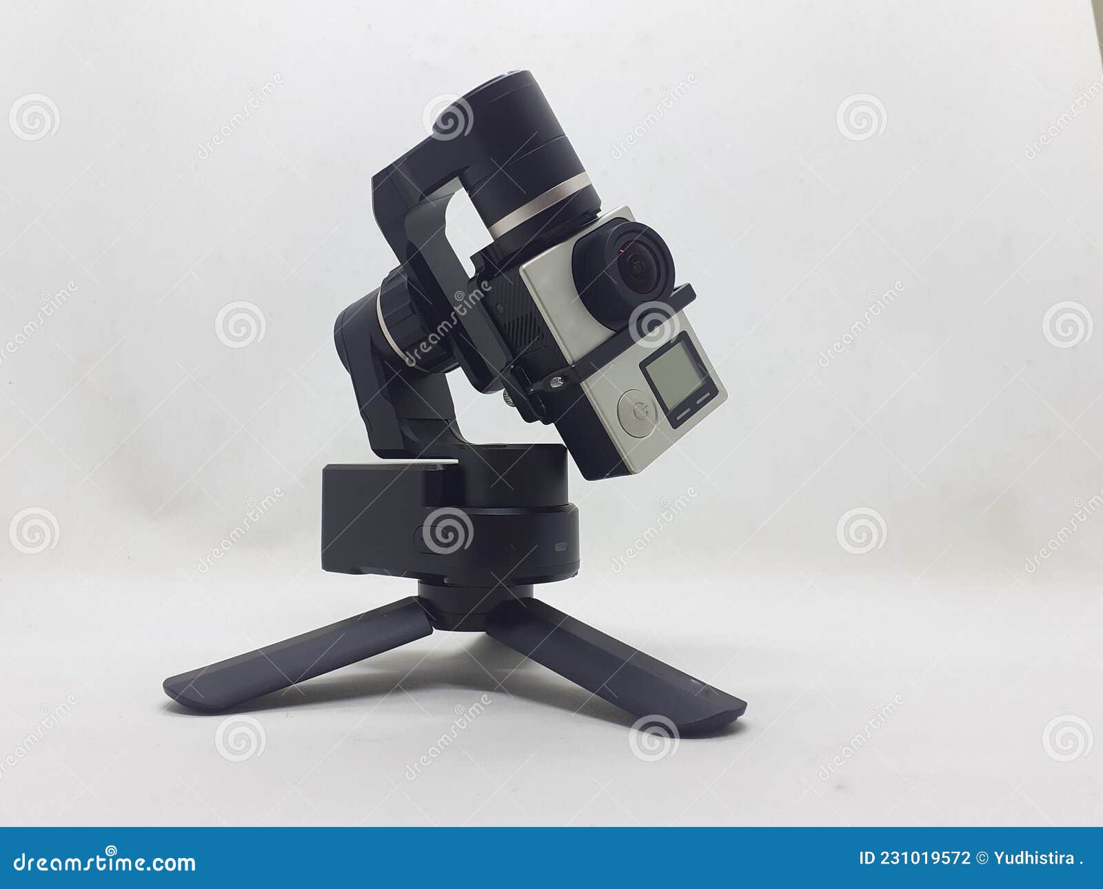 A Small Black and Grey Action Camera with Its Accessories on White ...