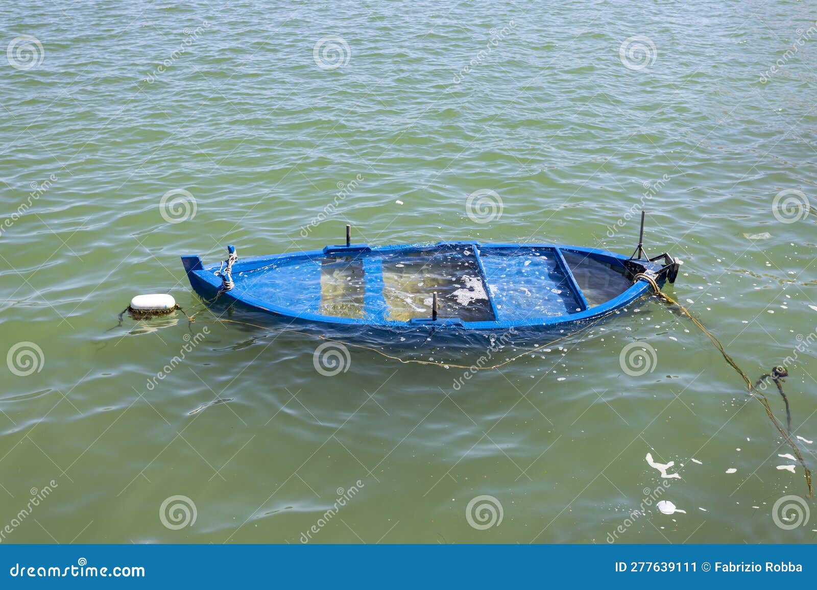 A Small Blue Boat Sinking into the Sea Stock Image - Image of water ...