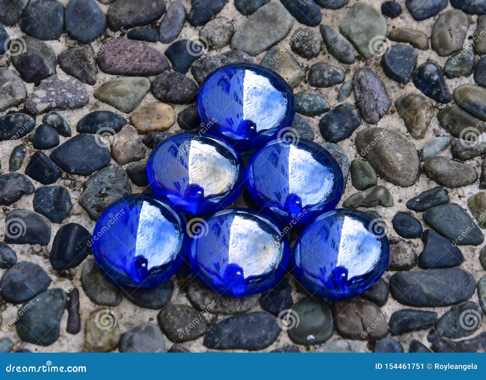 Small Blue Triangle on Pebblestone Background Stock Image - Image of ...