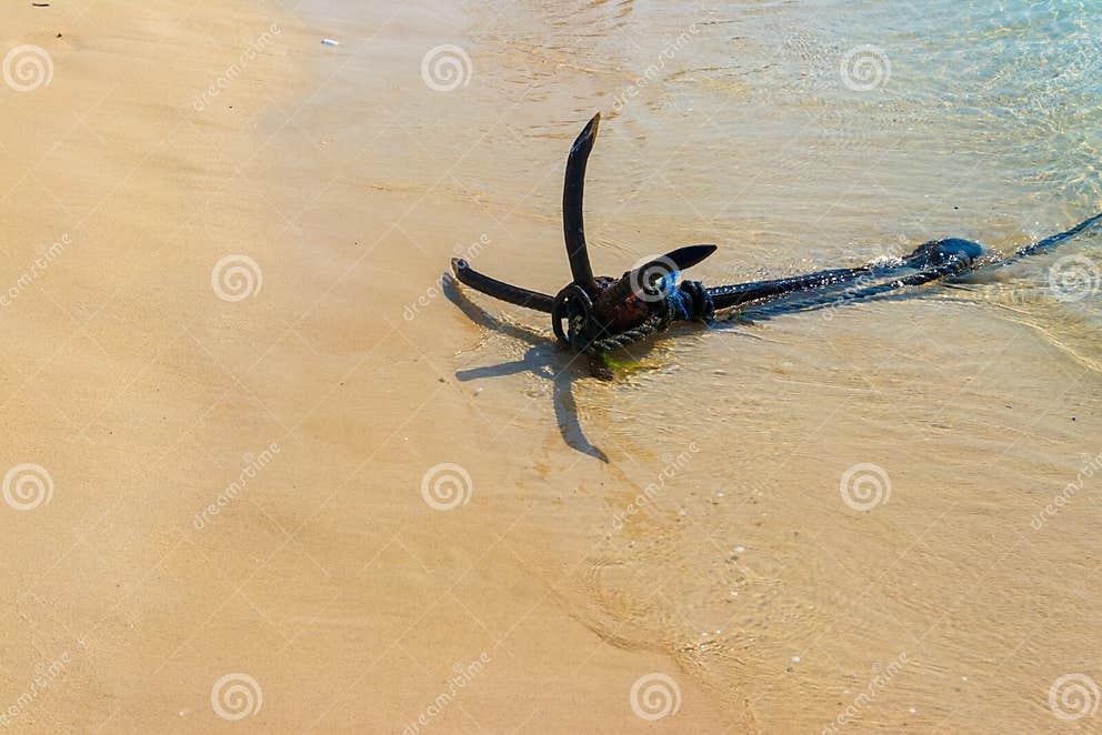 Small Boat Anchor on Shore of Ocean Stock Photo - Image of cord, calm ...