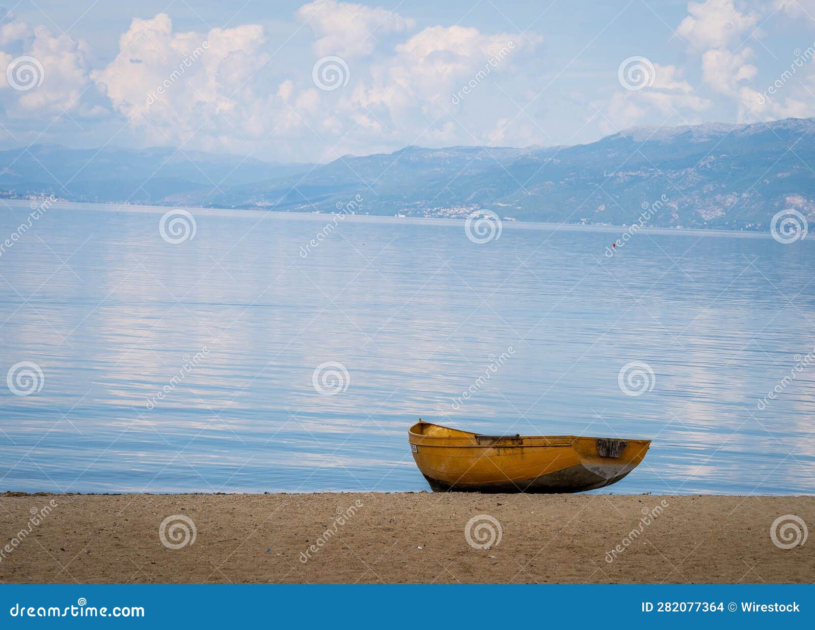 Small Boat Beached on the Shoreline of a Tranquil Lake Stock Photo ...
