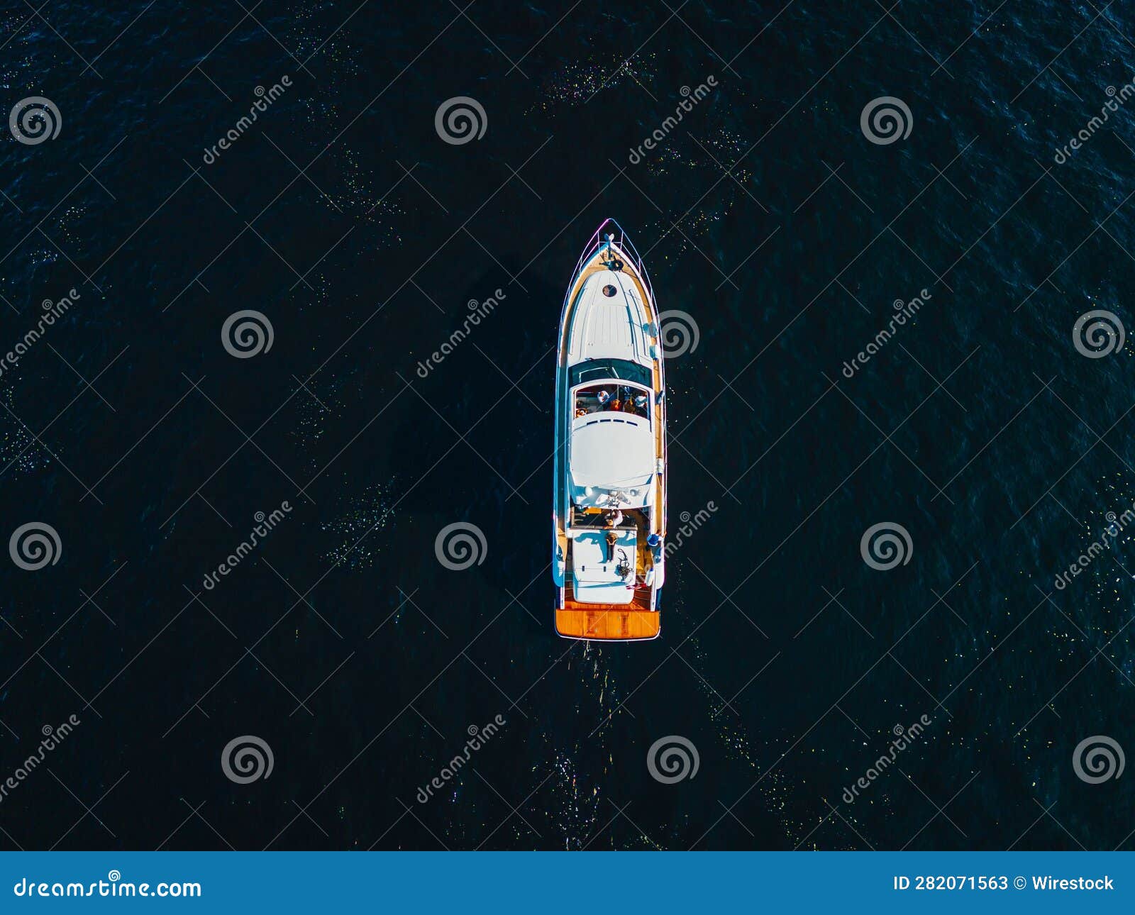 Small Boat Sailing through the Tranquil Waters with a Bright Orange ...