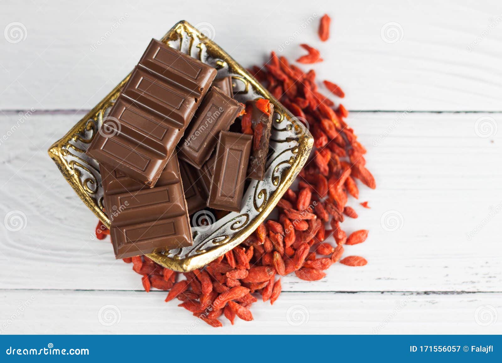 Chocolate Bar with Goji Berries in a Ceramic Dish on White Wood Planks ...
