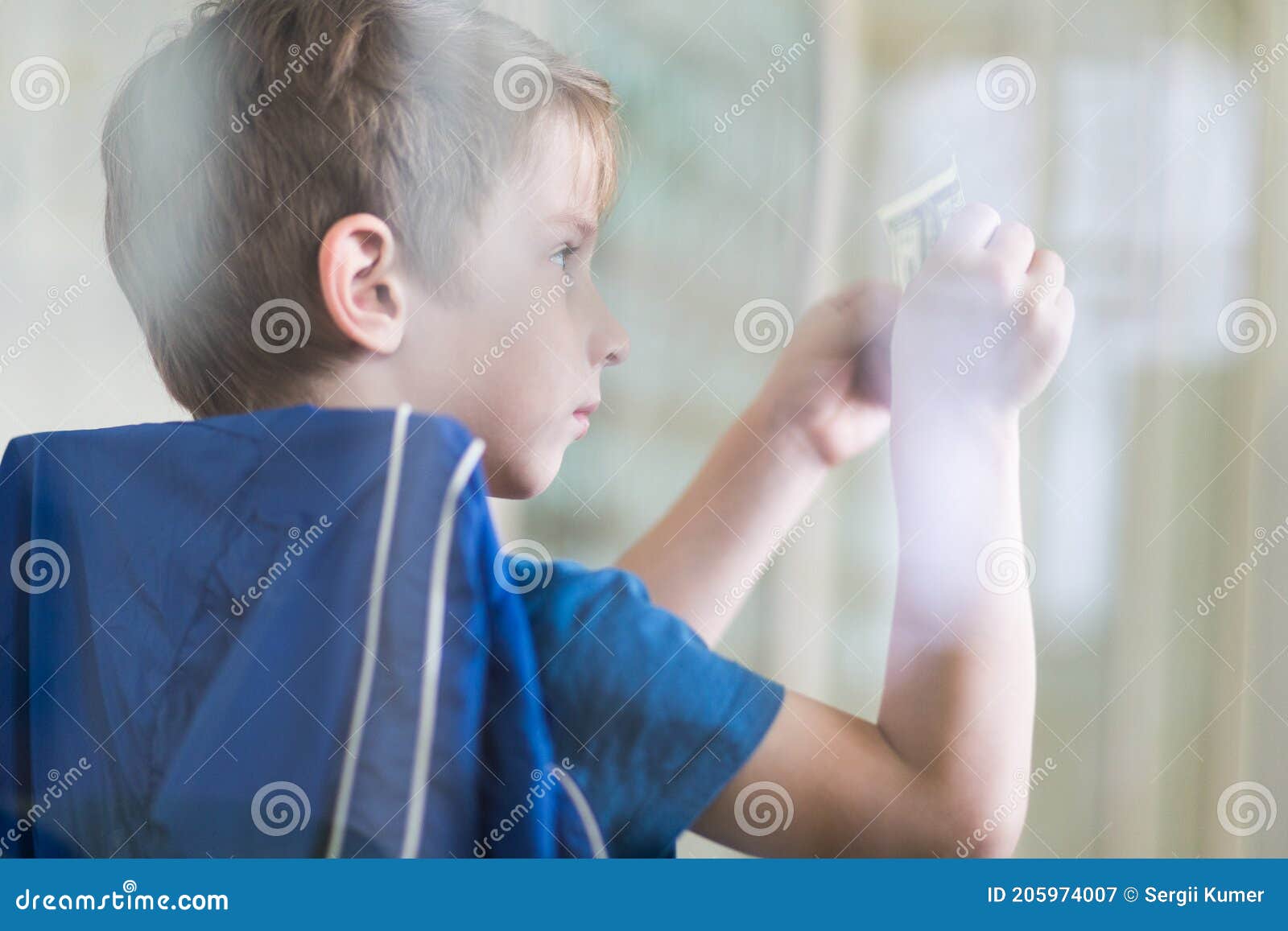 Small Boy Checking Watermarks on the Dollar Bill Stock Image - Image of ...