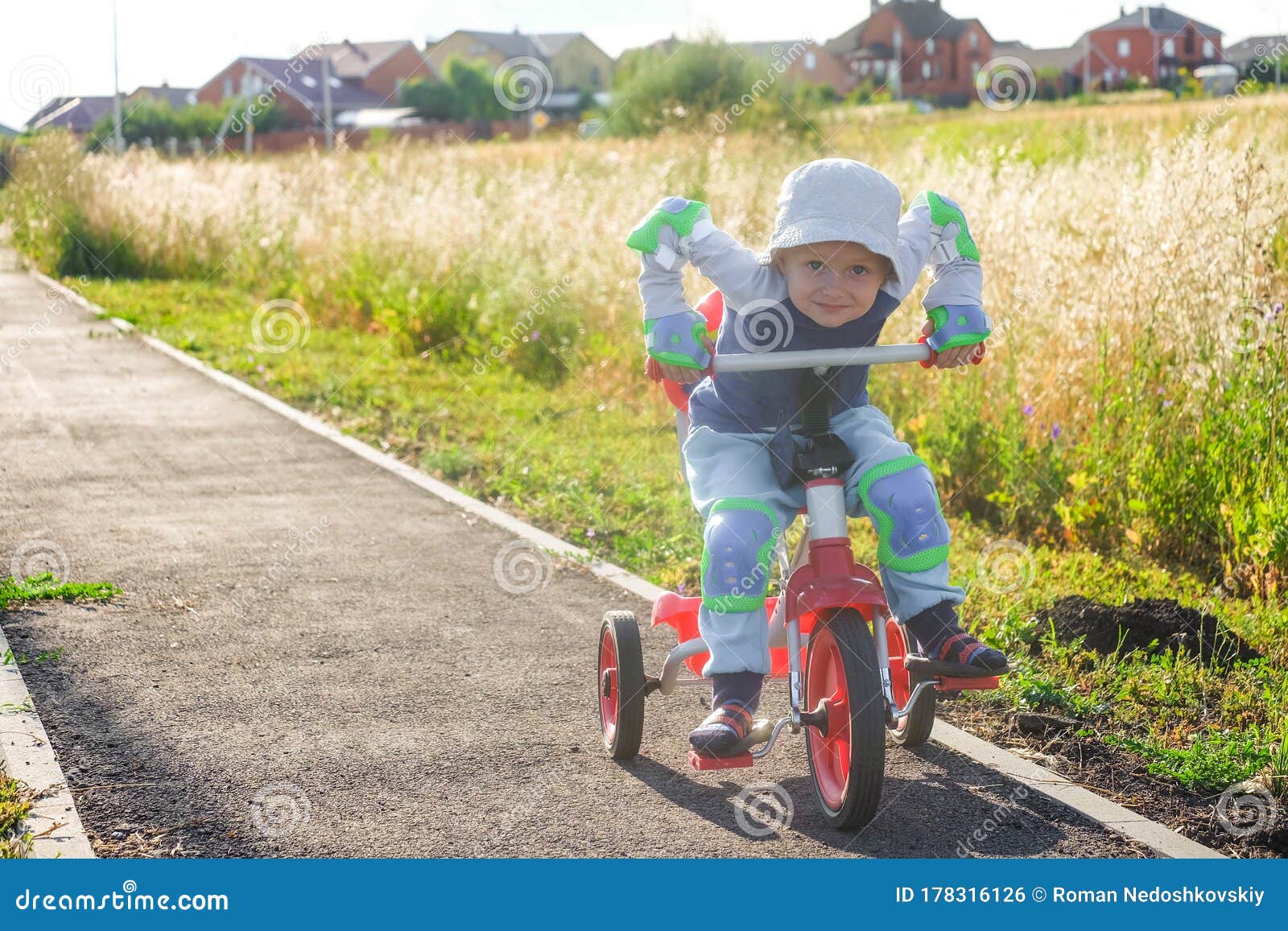 Small Boy Rides a Tricycle on a Track in the Suburb Stock Photo - Image ...