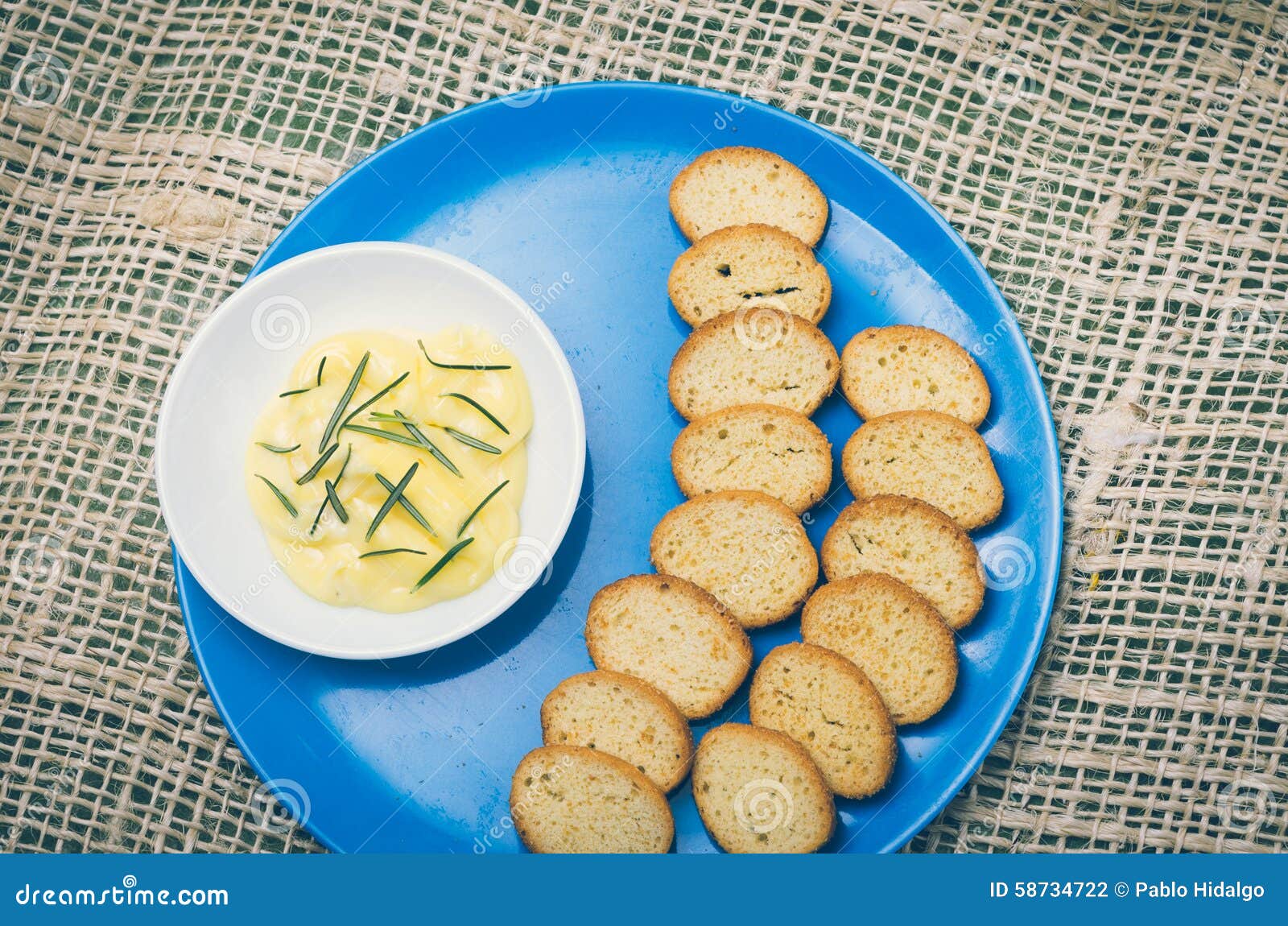Small Bread Slices and Butter Rosemary on Blue Stock Photo - Image of ...