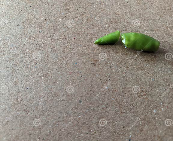 A Small Broken Green Chili on Brown Stock Image - Image of small, brown ...