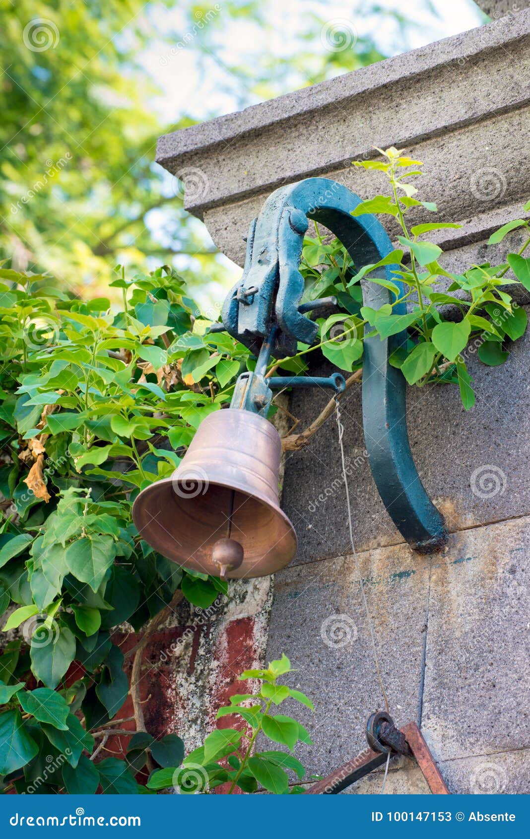 Small Bronze Bell on a Stone Wall Stock Image - Image of suspend ...