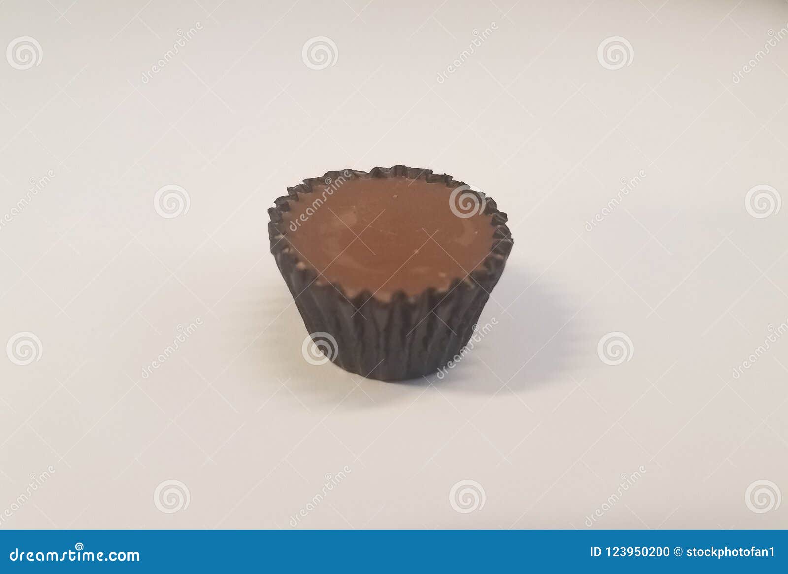 Small Brown Chocolate Candy in Wrapper on White Surface Stock Photo ...
