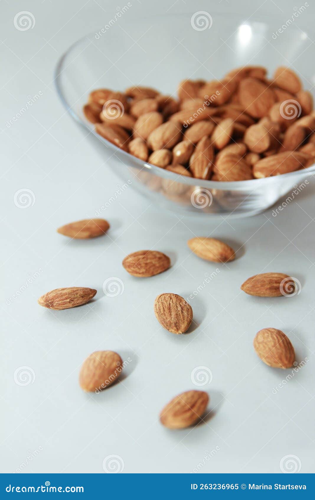 Small Brown Grains of Natural Almonds in a Decorative Plate on a Blue ...