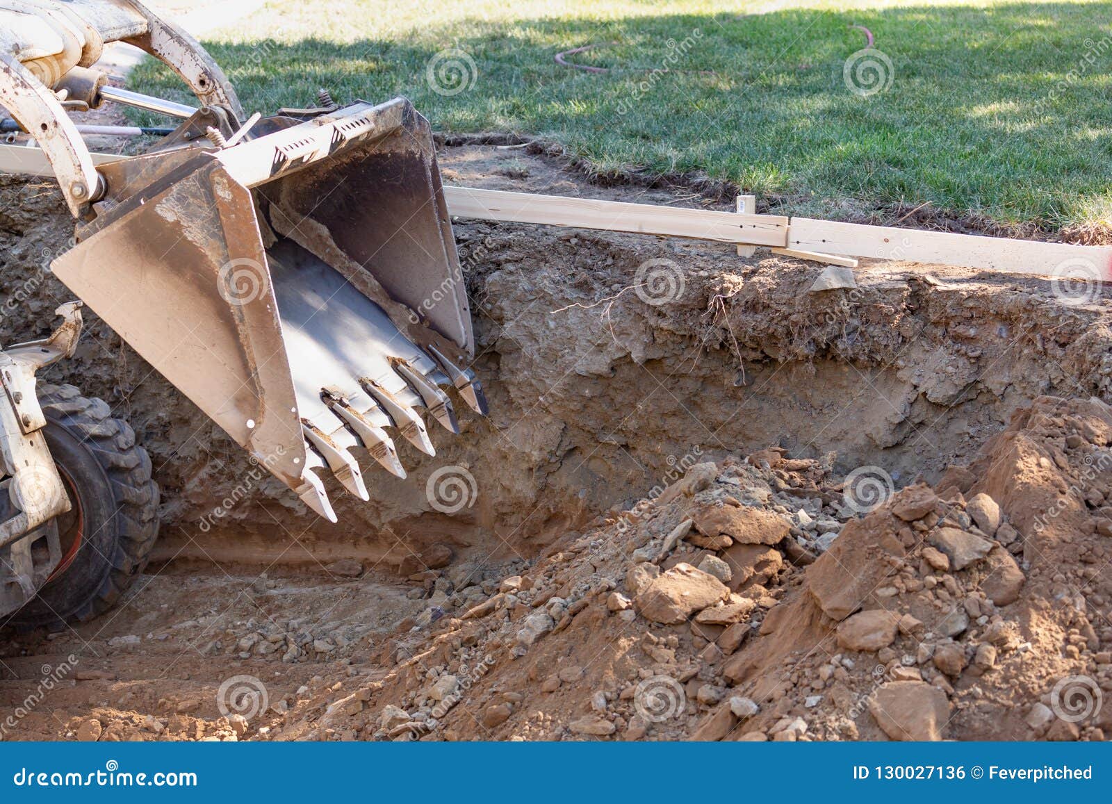 A Bulldozer Digging in Yard for Pool Installation Stock Photo - Image ...