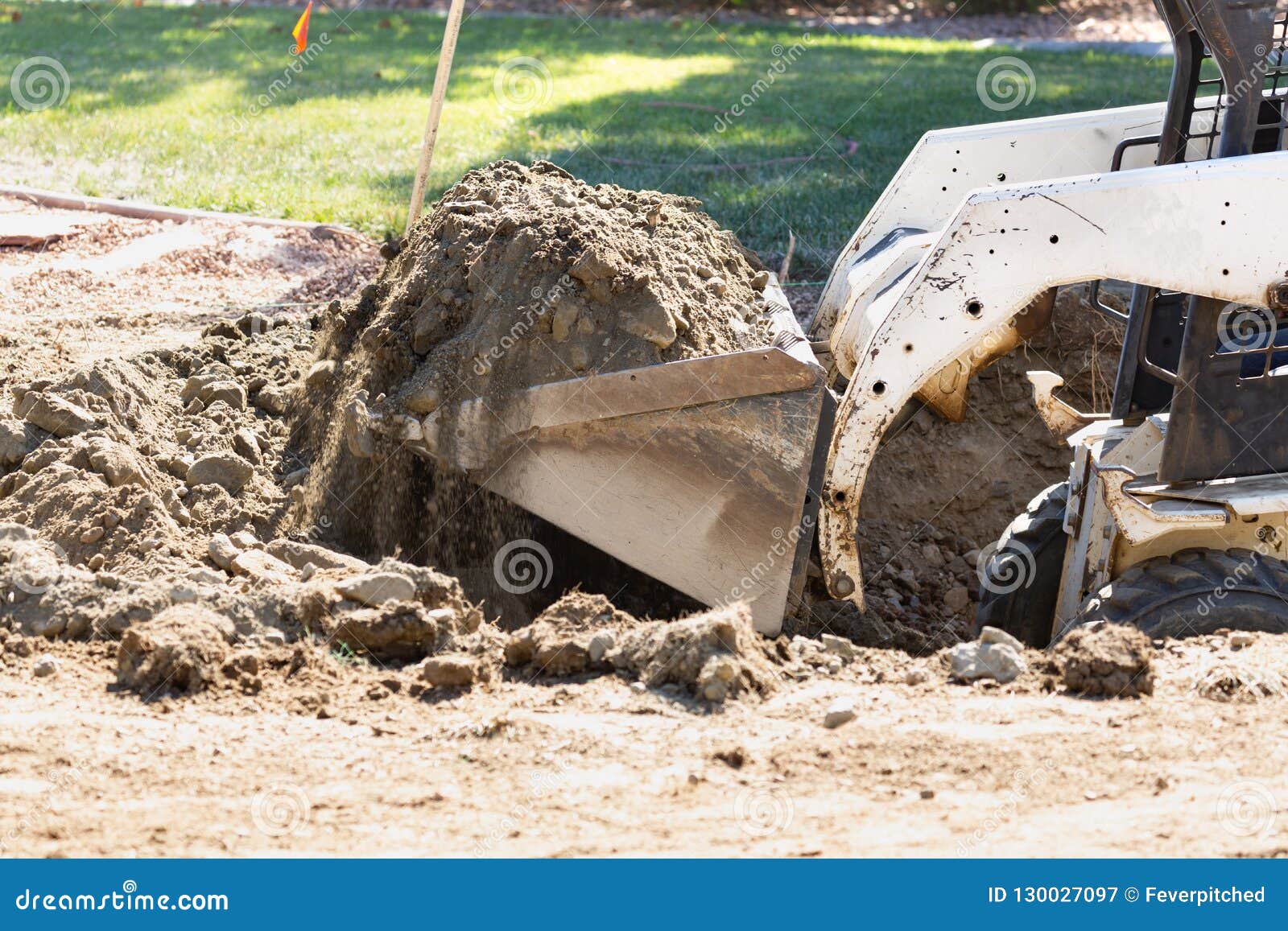 Small Bulldozer Digging Up Dirt and Grass Stock Image - Image of small ...