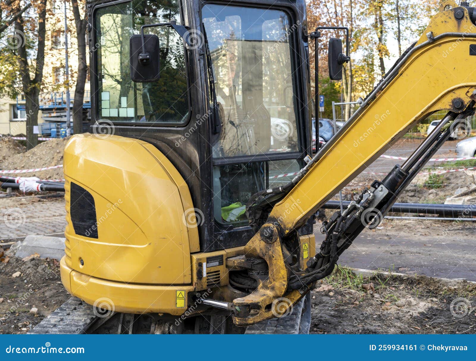 Small Bulldozer at Work. Orange Excavator on the Road Stock Image ...