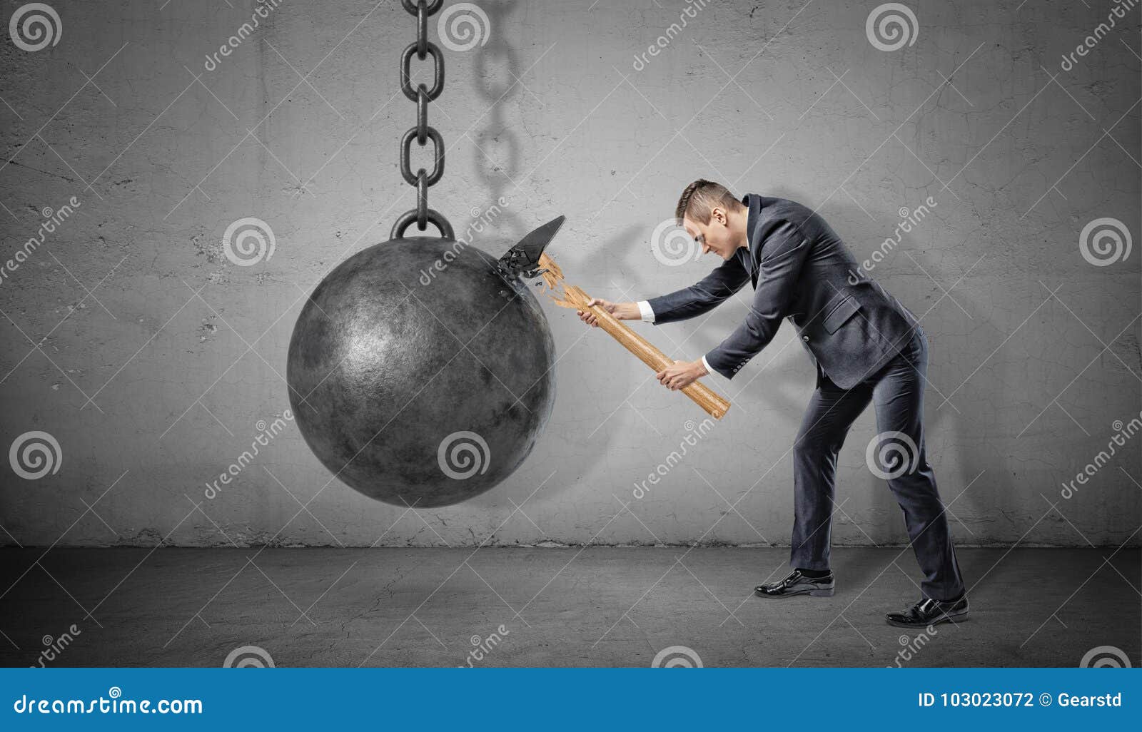 A Small Businessman Hits a Large Solid Iron Ball with a Breaking Hammer ...