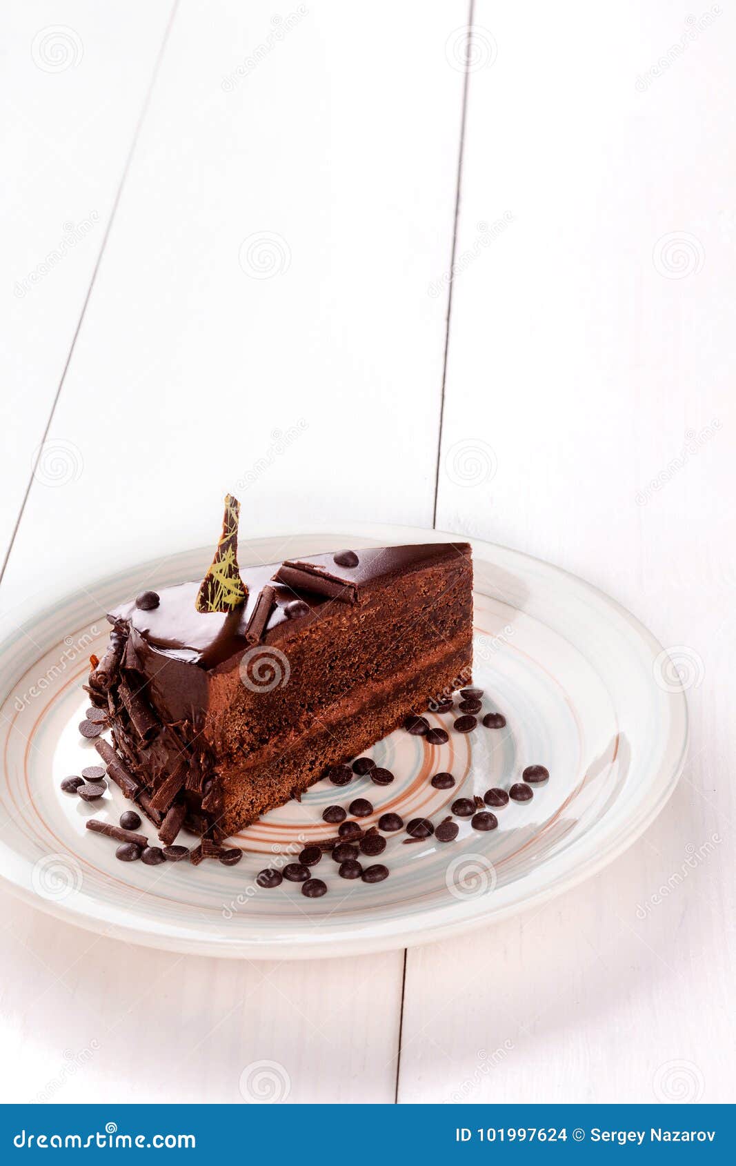 Small Cake with Different Stuffing on a White Plate. White Wooden Table ...