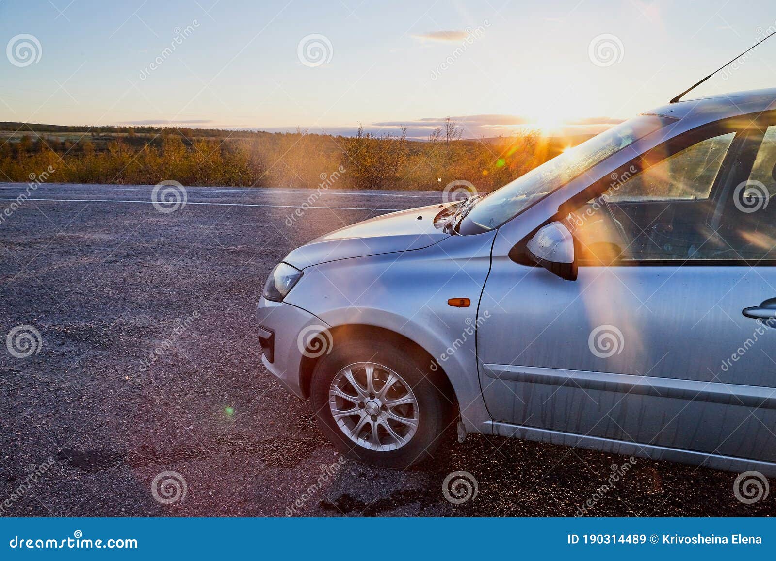 Small Car Standing on the Side of Asphalt Road and Sunset or Sunrise ...