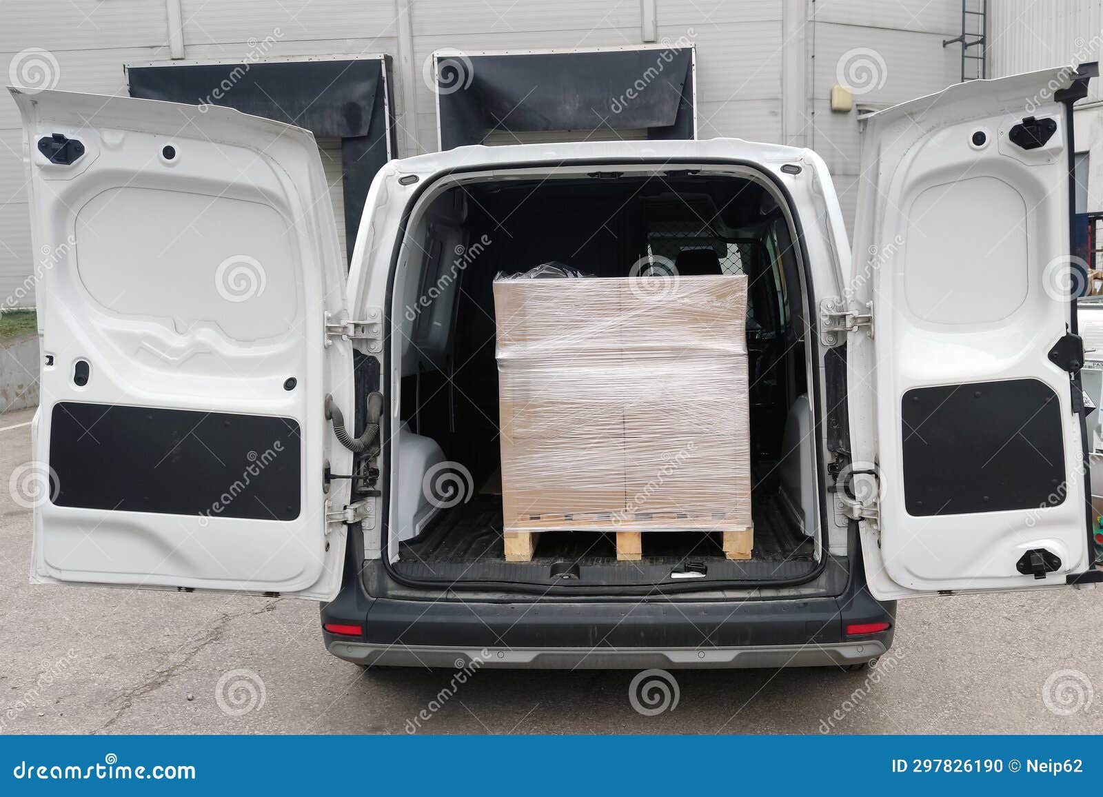 A Small Cargo Van with Cargo on a Pallet in the Car Stock Photo - Image ...
