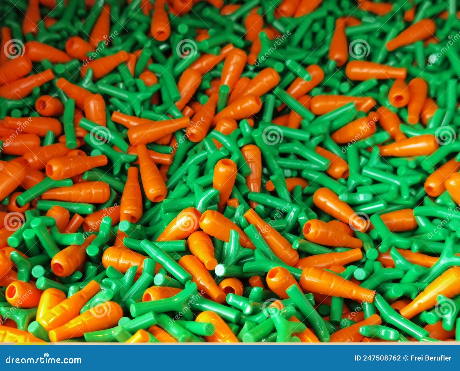 Small Carrots and Green Plastic Stems Stock Photo - Image of group ...